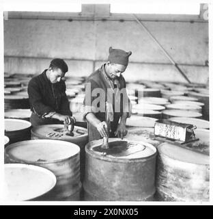 Personnel of the Bulk Petroleum Storage Company fill barrels with fuel ...