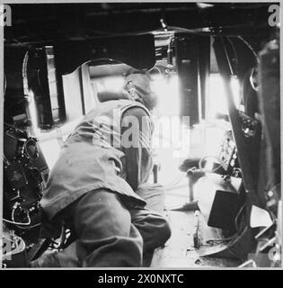 Inside a Halifax aircraft of RAF Bomber Command, an engineer monitors ...