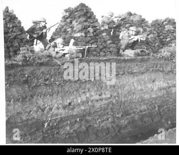 A sniper patrol takes cover among stacked peat in a Northern Ireland ...