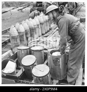 Cordite charges are removed from papier-mâché containers for disposal ...