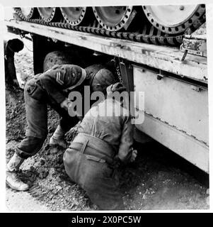 British Army personnel rescue a tank transporter stuck in terrain by ...