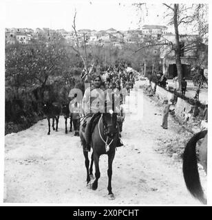 Indian soldiers with mules move through the streets of San Nicola ...