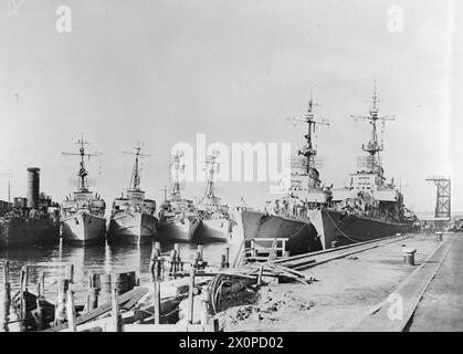 May 1945, bomb-damaged and surrendered German warships are visible at ...