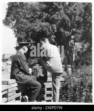 General Sir John Dill and Mr. Eden are pictured on a terrace observing ...