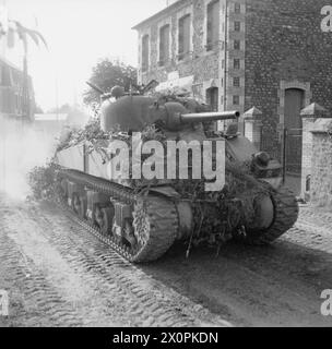 A British Army Sherman tank crewman navigates heavy mud conditions in ...