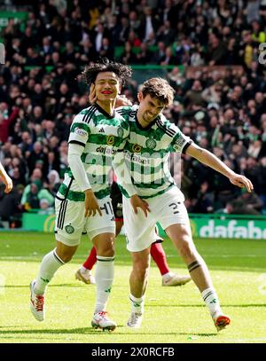 Celtic's Reo Hatate (left) celebrates after scoring his sides first ...