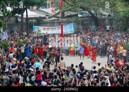 A Hindu monk swings from a rope tied to a wooden pole and attached ...