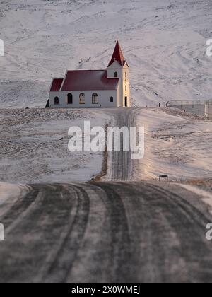 Icy snow covered road leading to a large highway. Close up of the ramp ...
