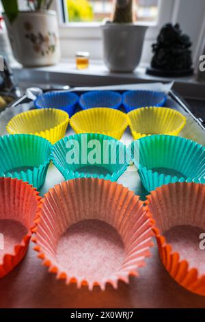 A vibrant display of baking cups in shades of green, light blue, and ...