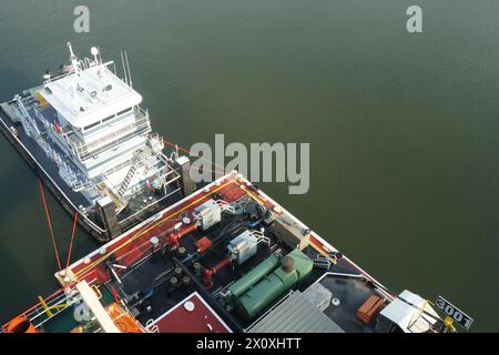 Tug boat and bunker barge with valves and manifolds observed from the ...