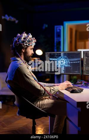Computer engineer using EEG headset, starting mind upload process using brain machine interface ...
