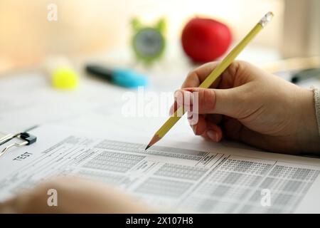 Female Pupil In Uniform Taking Multiple Choice Examination Paper Stock ...
