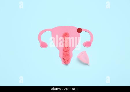 Paper uterus with menstrual cup on grey background Stock Photo - Alamy