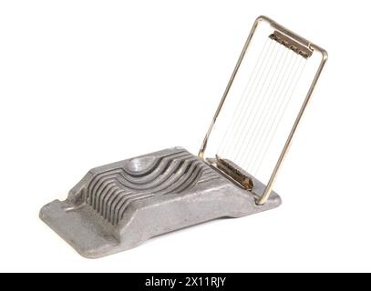 Very old egg cutter isolated on a solid background Stock Photo - Alamy