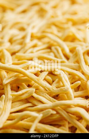 Raw dried spaetzle egg noodle. Isolated on white background. Top view ...