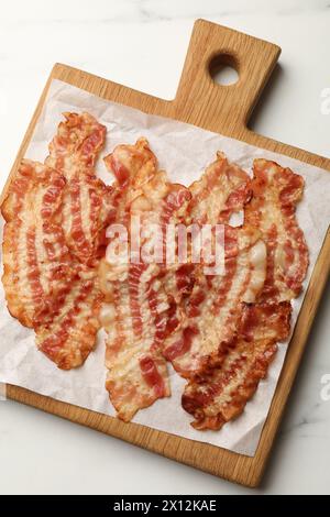 Delicious fried bacon slices on white wooden table, top view Stock ...