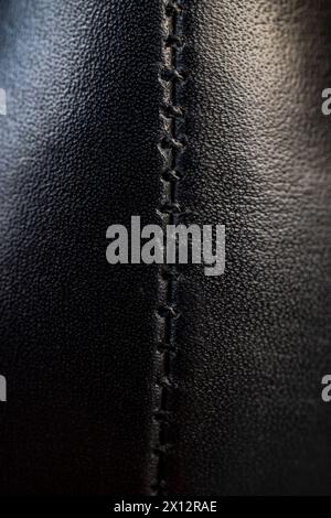 a black leather object sewn from several parts, part of a shoe made of ...