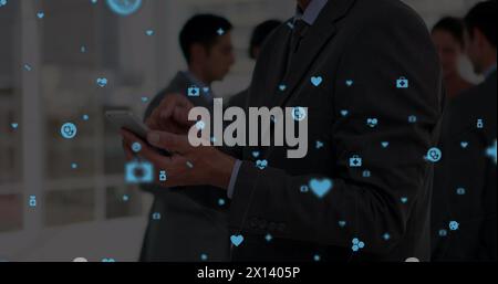 Image of falling icons over men using smartphone Stock Photo - Alamy