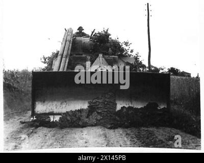 The Sherman bulldozer, an adapted Sherman tank, clears roads in forward ...
