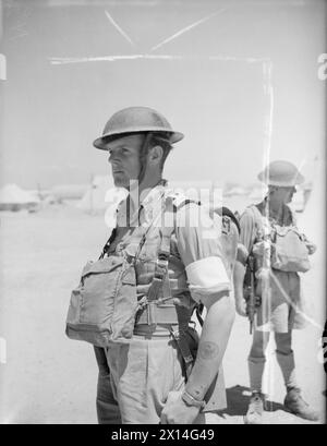 At HMS Saunders near Kabrit, Bitter Lakes, two men erected a beach sign ...