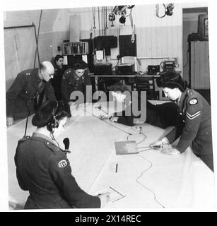 ATS personnel work in the plotting room, using a large-scale map of the ...