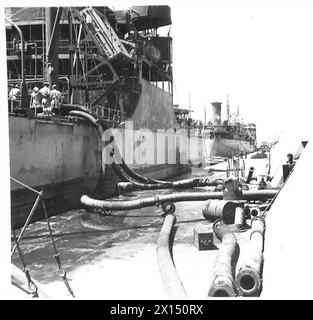 Personnel discharge a tanker at the docks for the Bulk Petroleum ...