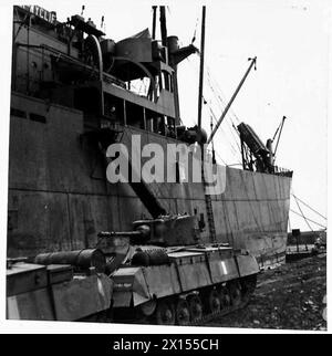 BRITISH AND AMERICAN TROOPS EMBARK - A Valentine tank goes aboard one ...
