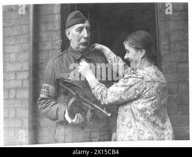 HOME GUARD : NEW WEAPONS - A final tidy up before going on duty. The ...
