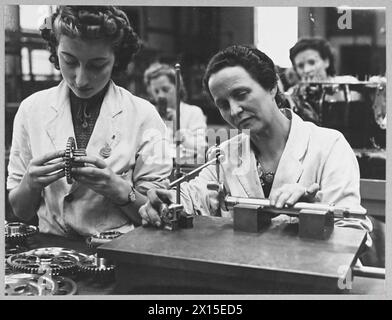 Women workers at a BOAC repair factory clean components of damaged RAF ...