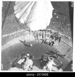 A trainee at the Parachute Training Depot and School prepares for a ...