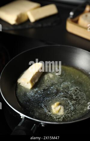 Melting butter in frying pan on table Stock Photo - Alamy