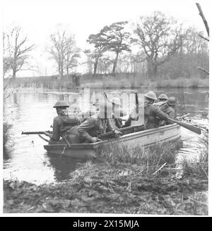 Troops use an assault boat to cross a river during a British Army ...