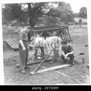 Royal Engineers construct a base for a Bailey bridge using cross ...