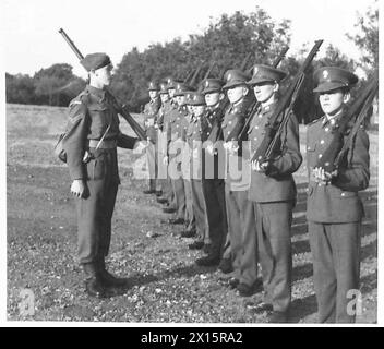 CADETS AFFILIATED TO HOME GUARD - A cadet being shown, by a Home Guard ...