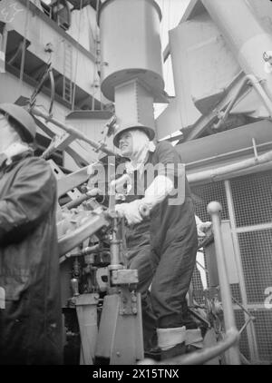 An able seaman aboard HMS Anson performs daily duties, including ...