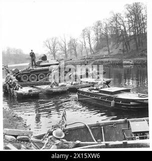 A Crusader tank is loaded onto a shore loading raft and ferried across ...