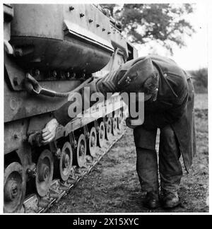 Personnel of the Experimental Tank Recovery Section attach a wire ...