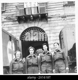Front-line nurses of the Eighth Army in Italy sit on stairs for a sing ...