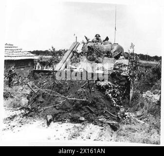 The Sherman bulldozer, an adapted tank with armament, clears roads in ...