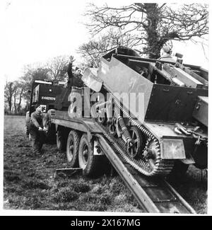 Royal Electrical and Mechanical Engineers winch a carrier onto a ...