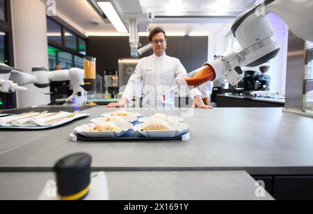 Dresden, Germany. 15th Apr, 2024. A collaborative robot prepares a salad at the opening of the ...