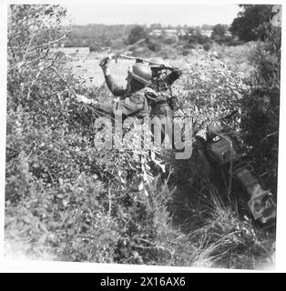 New Recce Corps troops camouflage a Bren carrier using branches during ...
