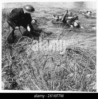IMPROVISATION - Troops swimming across a river pulling a raft carrying ...
