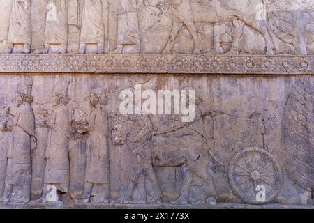 Detailed stone engravings depicting people and animals in motion. A ...