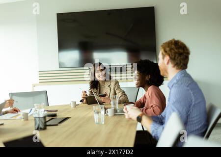 Multicultural group of professionals collaborates around a conference ...