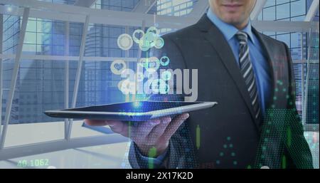 Businessman holding digital icons Stock Photo - Alamy