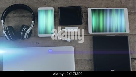 Image of technological devices with colorful moving shapes on screen on ...