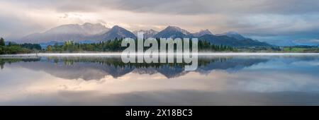 Sunrise at Lake Hopfensee near Fuessen, behind Hopfen am See, the ...