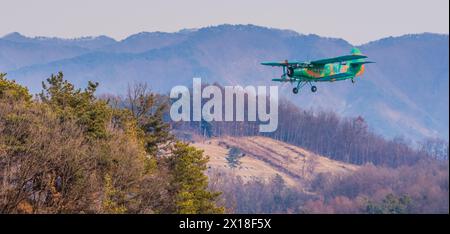 ROK military biplane training aircraft flying over overhead in clear ...