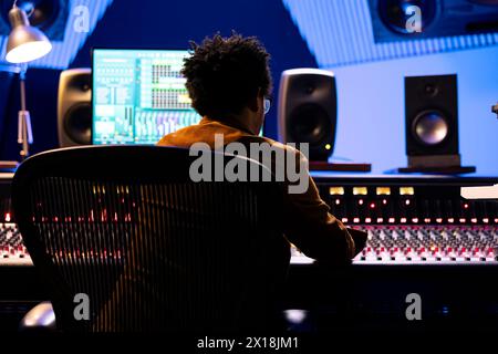 African american expert working at mixing panel in recording studio ...